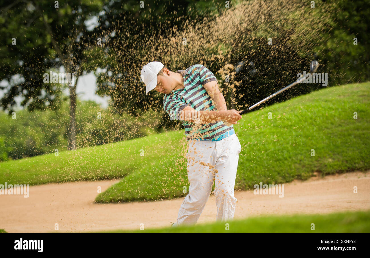 Asian man golfing on the course hi-res stock photography and images - Alamy