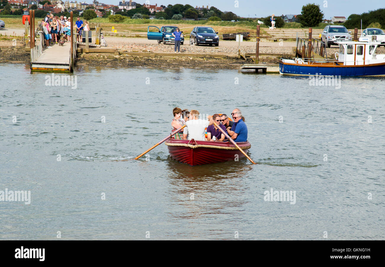 Man using rowing boat ferries families across the river Blythe in ...