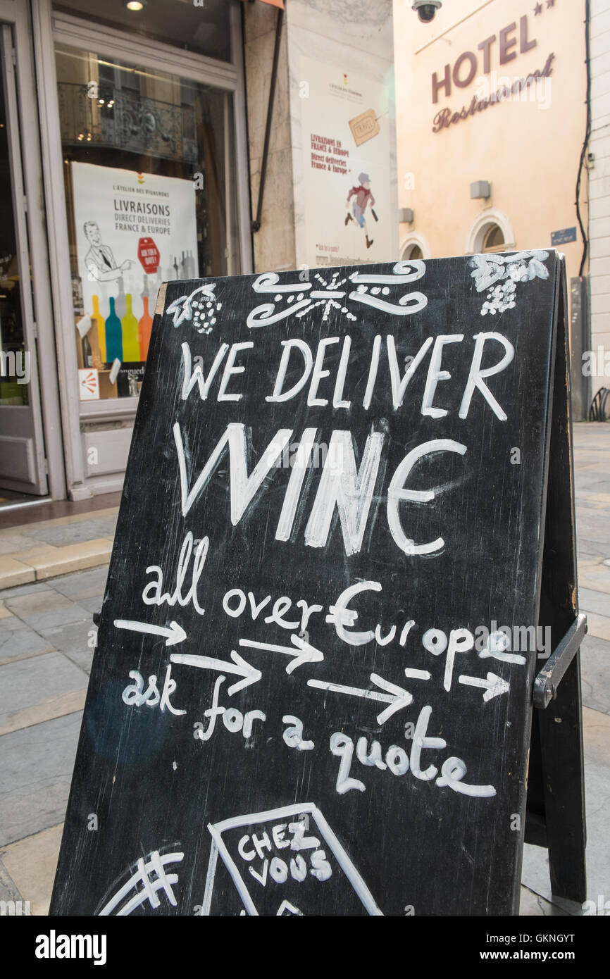 We deliver wine sign,signage outside wine selling shop in centre of ...