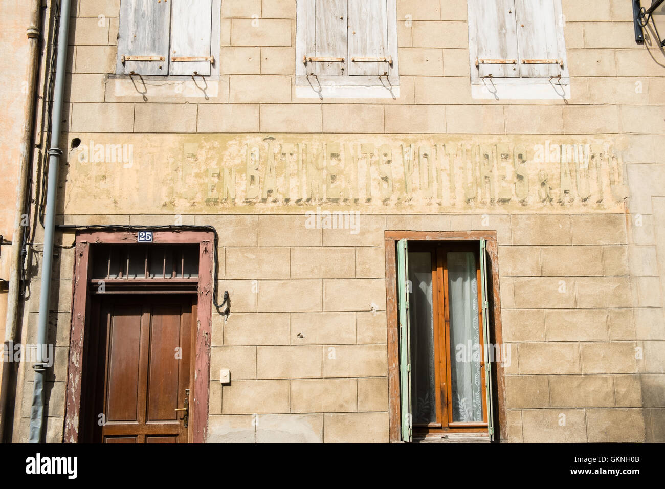 Faded signage advertisement along wall in Limoux town in Aude,South of ...