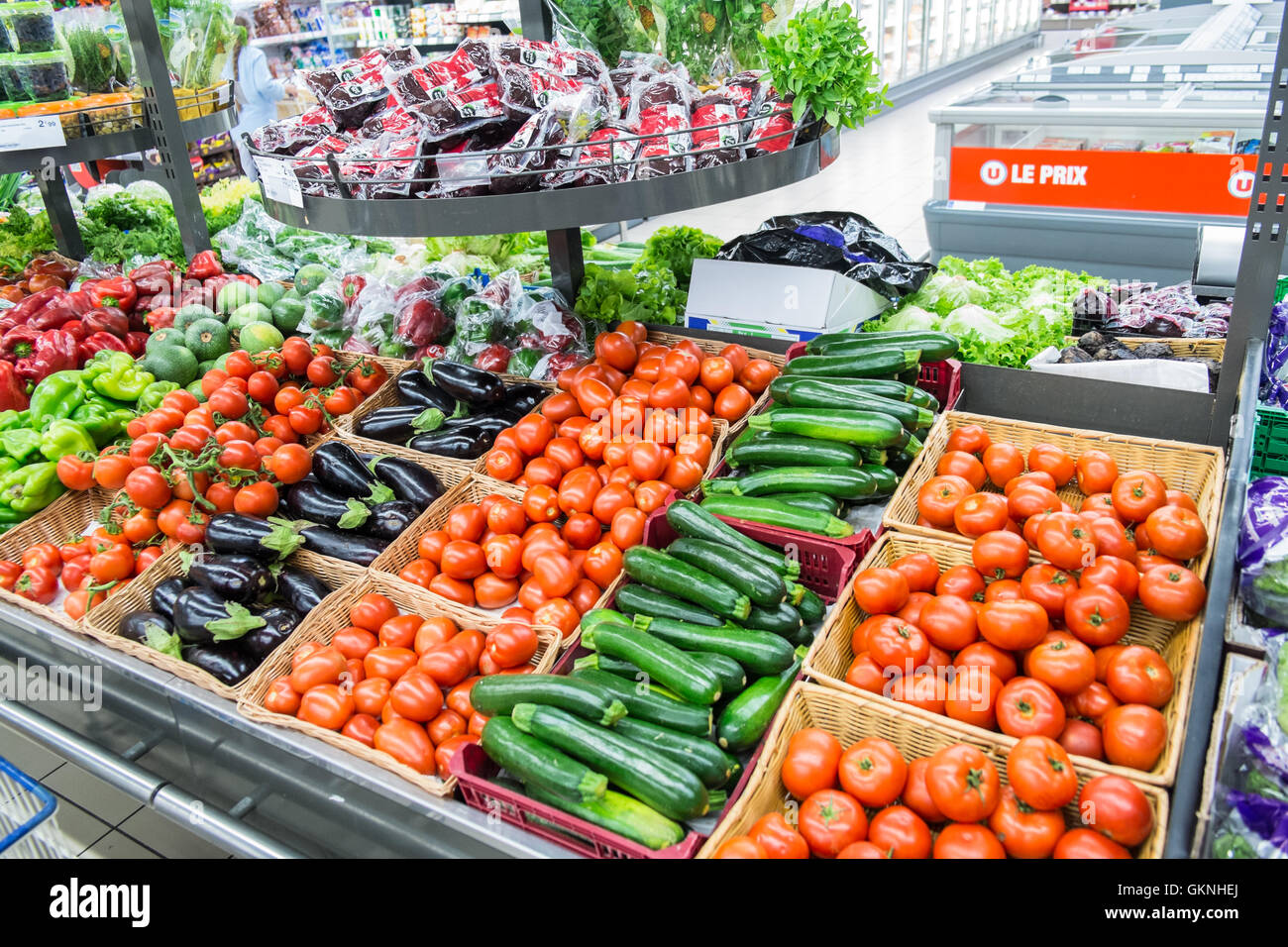 Vegetables section with tomatoes and courgettes at supermarket in ...