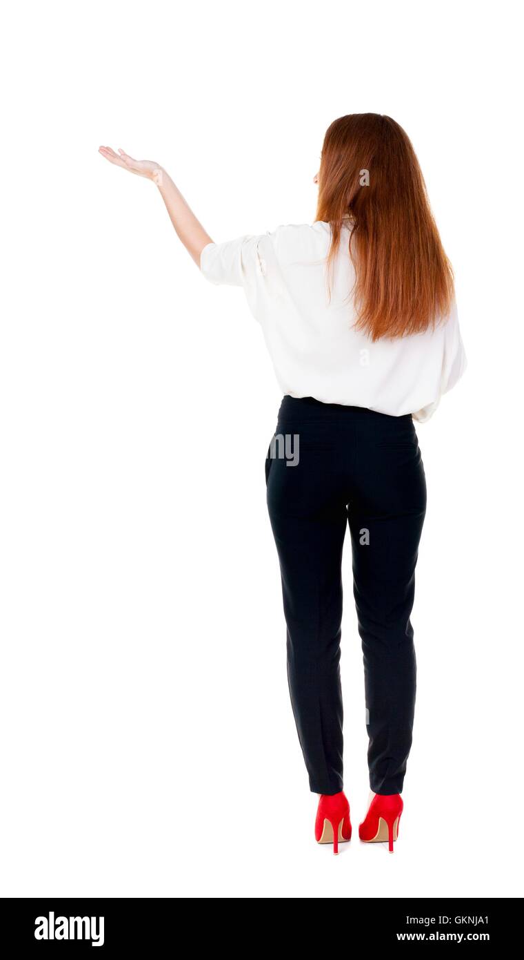 Back view of Beautiful business woman in suite looking at wall and ...