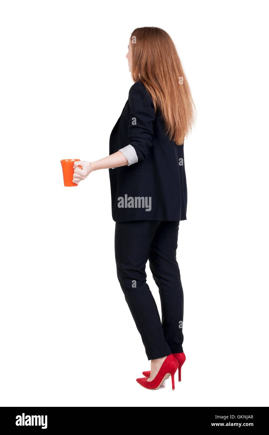 Rear view of a young business woman drinking coffee or tea while Stock ...