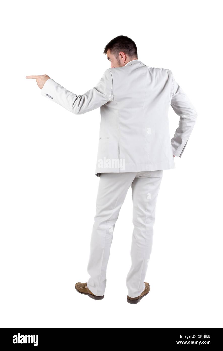 Businessman pointing at wall. rear view Stock Photo - Alamy