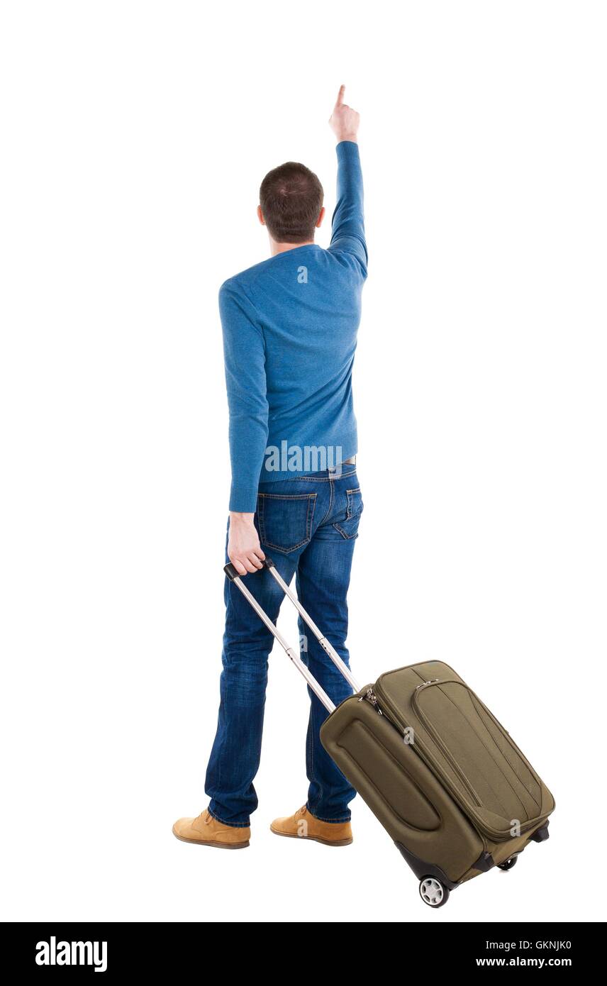 back view of pointing man with suitcase Stock Photo - Alamy
