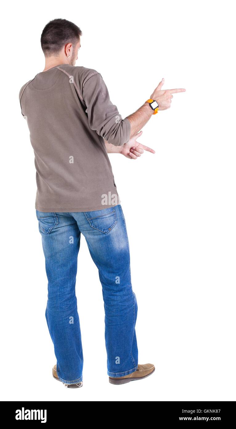 young man pointing at wall. rear view Stock Photo - Alamy