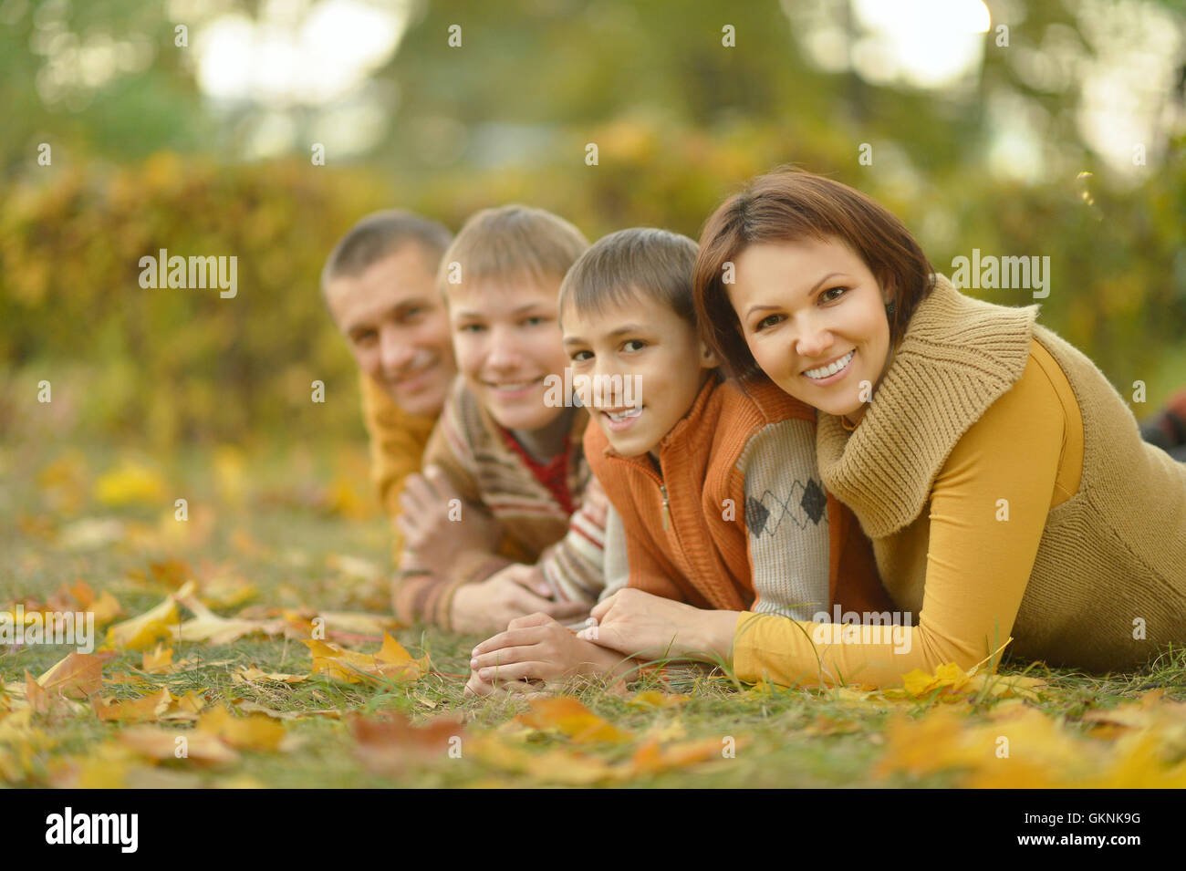 Happy family in autumn forest Stock Photo - Alamy