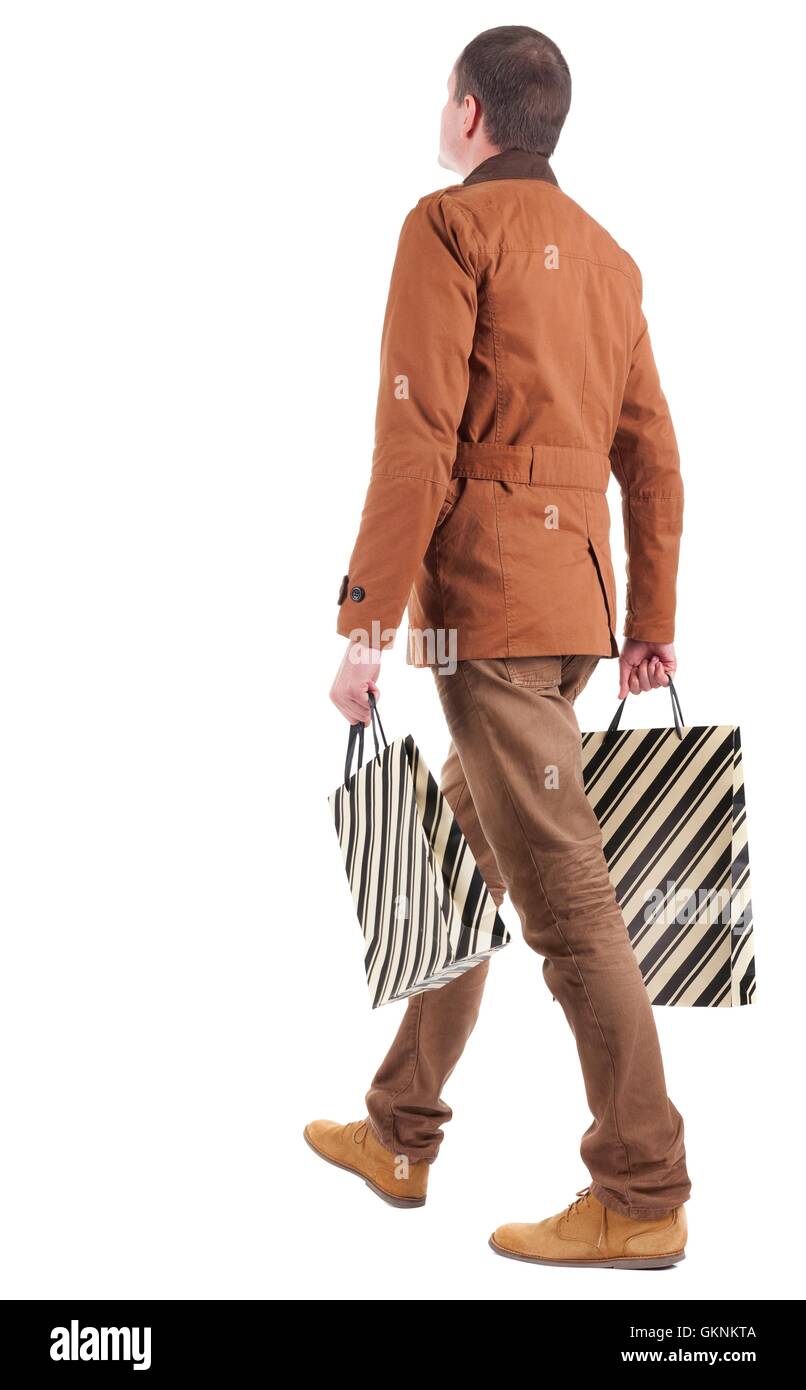 Back view of going handsome man with shopping bags Stock Photo - Alamy