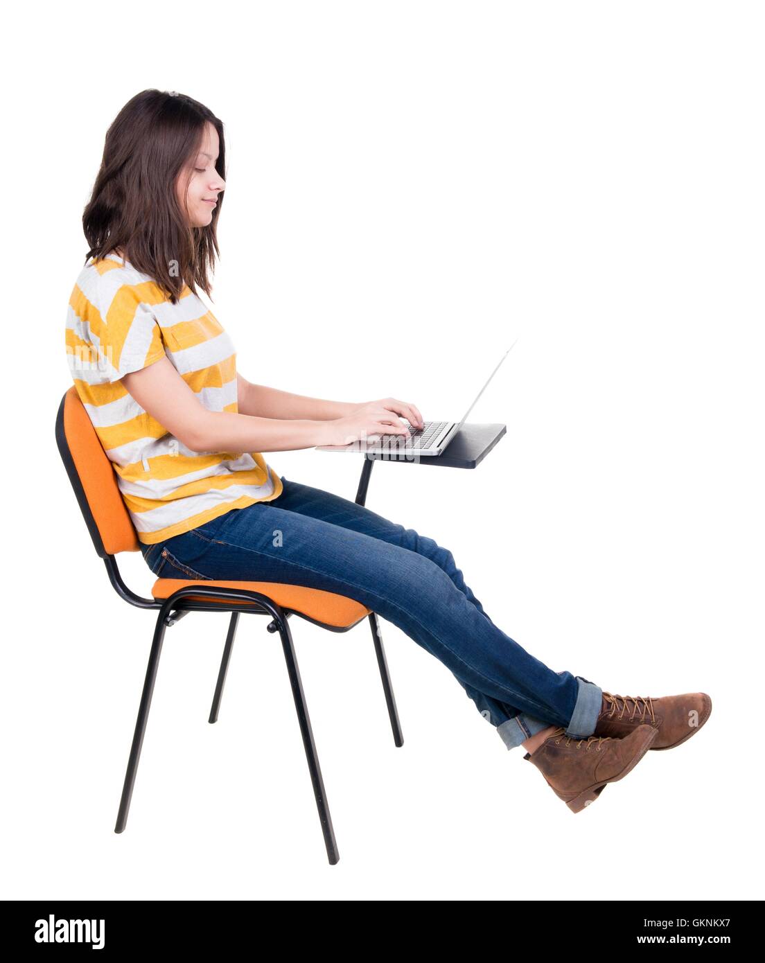 Side view of woman sitting on a chair to study with laptop Stock Photo ...