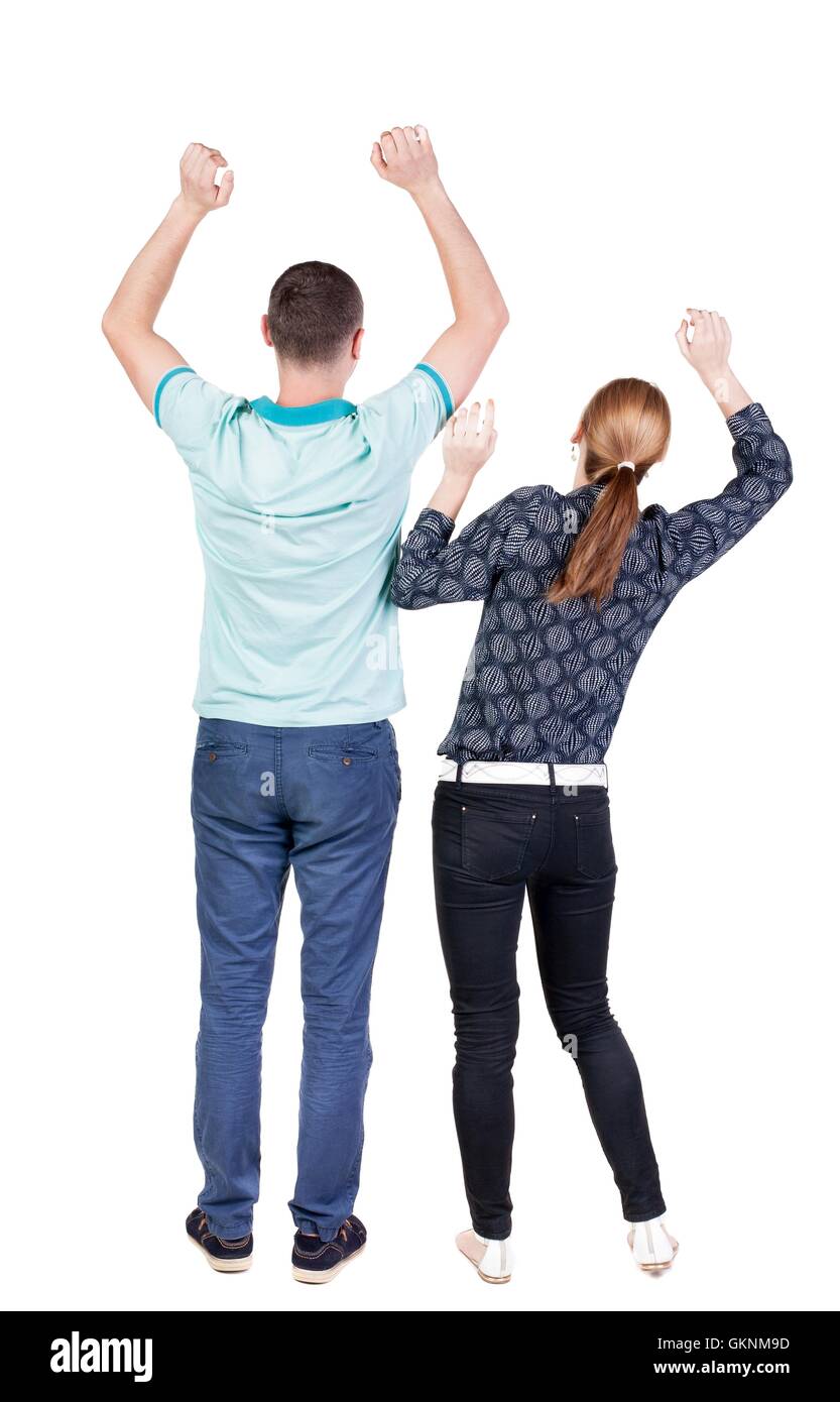 Back view of joyful couple celebrating victory hands up Stock Photo - Alamy