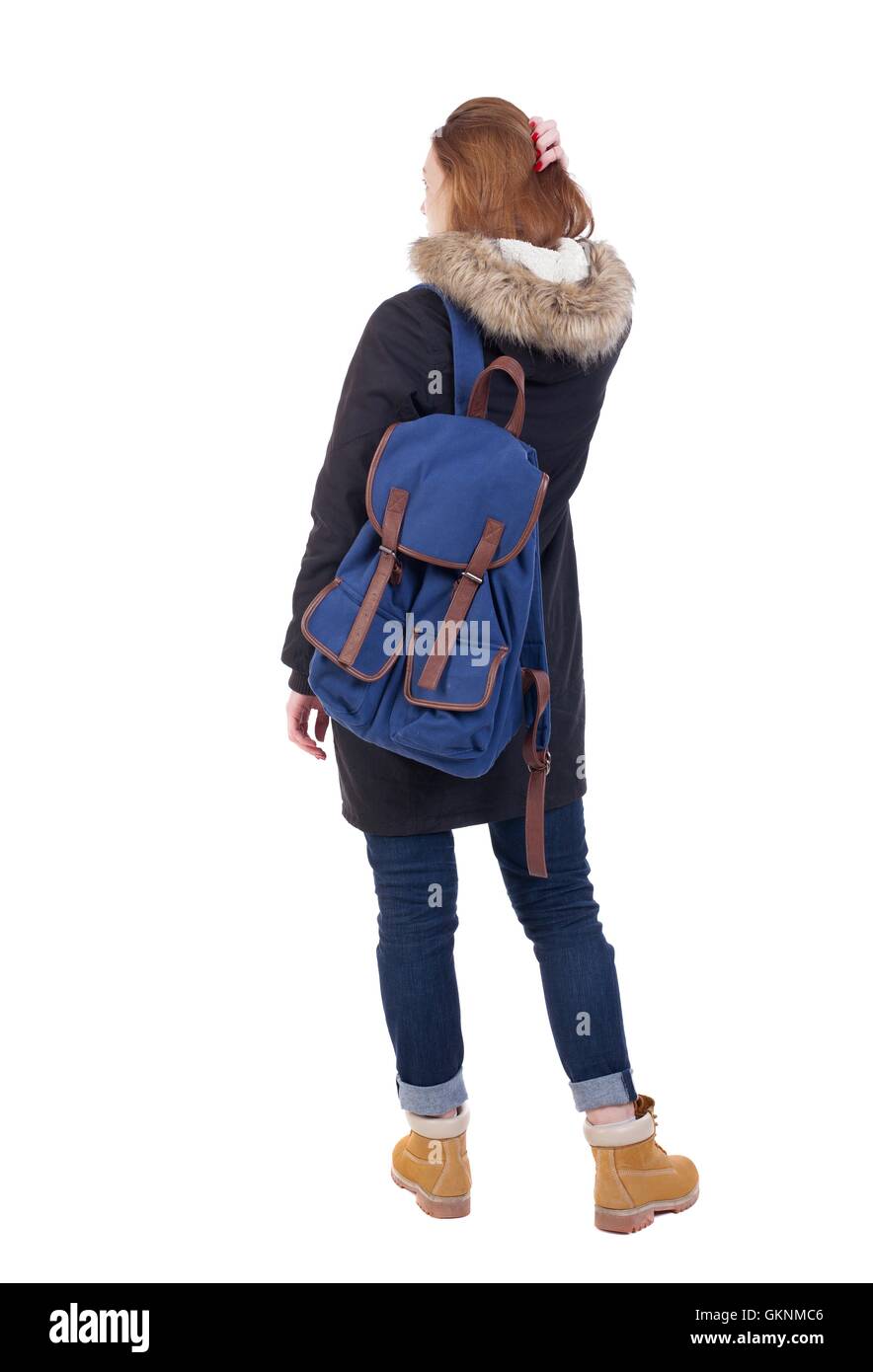 Back view woman in winter jacket with a backpack looking up Stock Photo ...