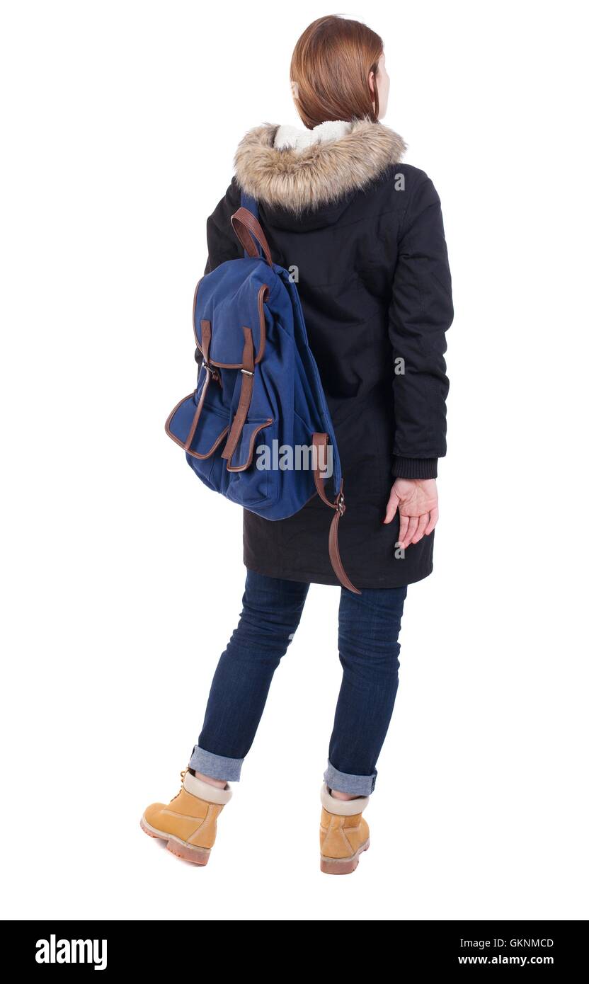 Back view woman in winter jacket with a backpack looking up Stock Photo ...