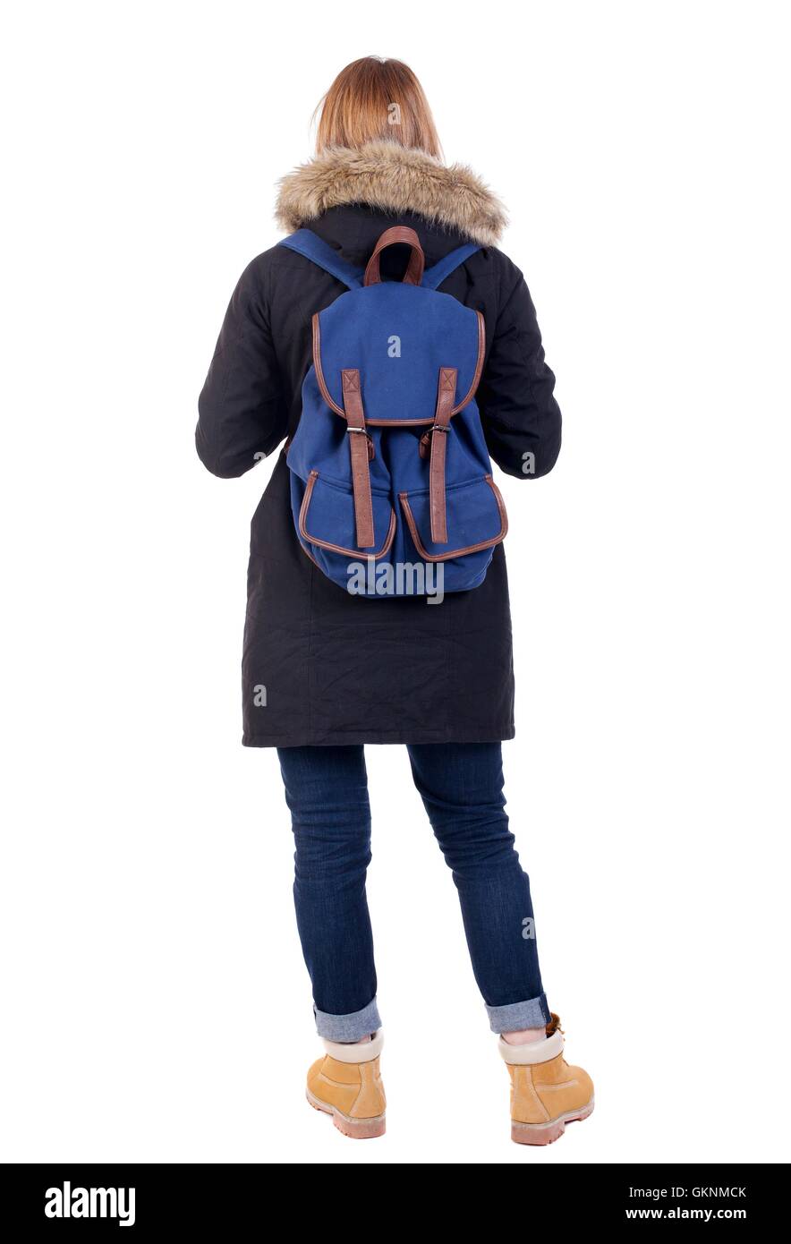 Back view woman in winter jacket with a backpack looking up Stock Photo ...