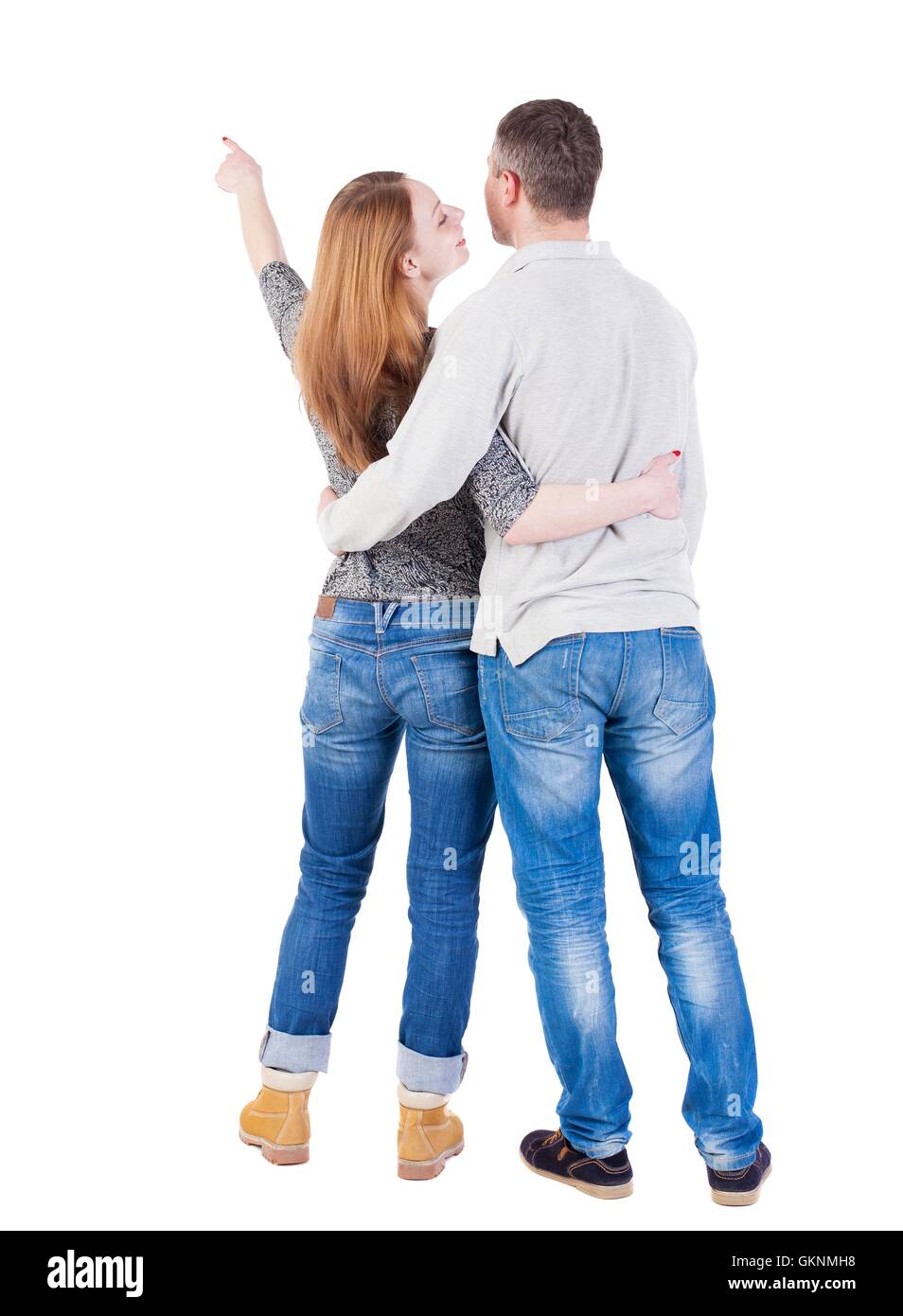 young couple pointing at wal Back view (woman and man Stock Photo - Alamy