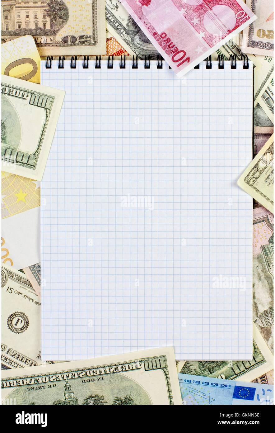 Opened spiral notepad on money background Stock Photo - Alamy