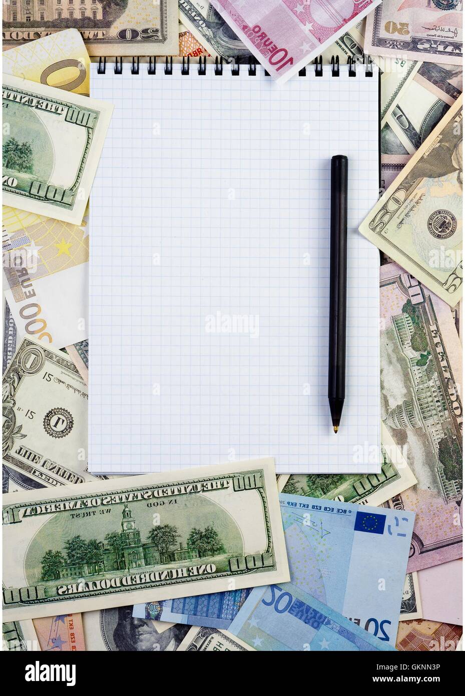 Opened spiral notepad on money background. with black pen Stock Photo ...