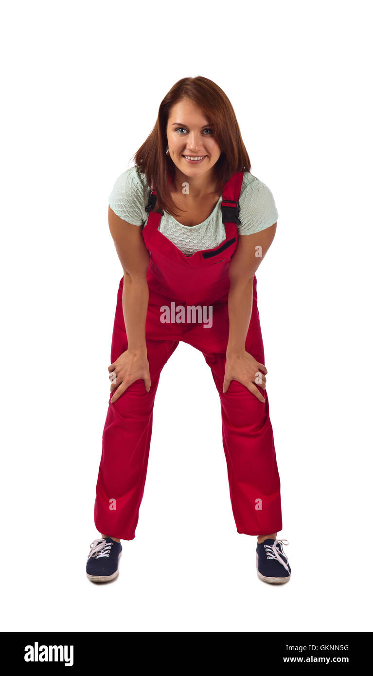 Young happy woman in red overalls , isolated on a white background ...