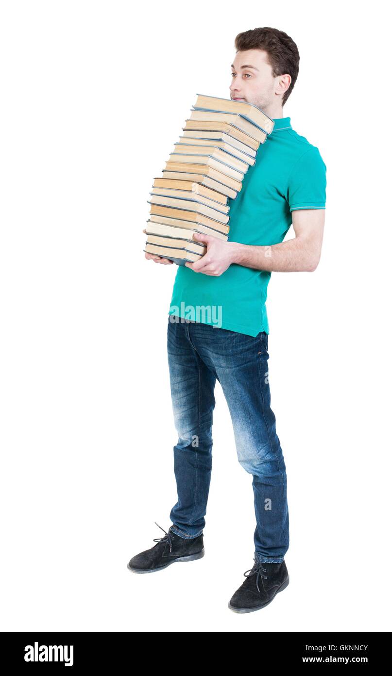 Back view of going handsome man carries a stack of books Stock Photo ...