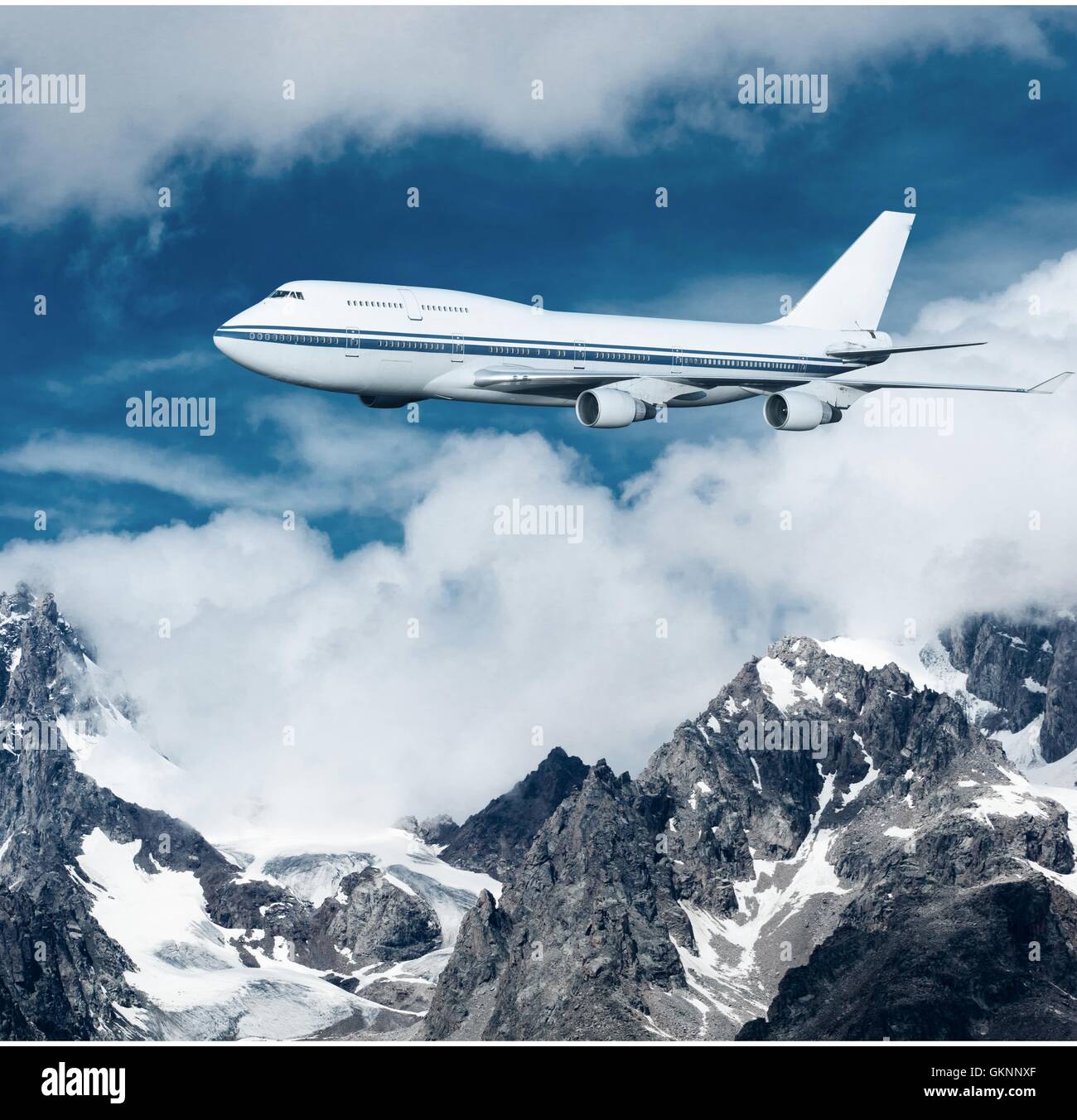 plane flying over the snow-capped mountains Stock Photo - Alamy