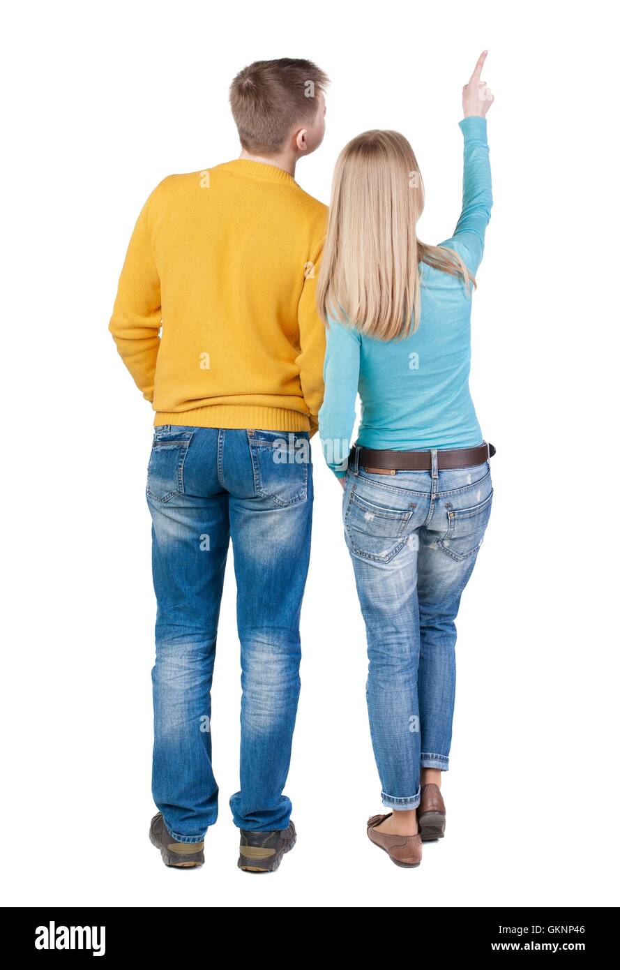 young couple pointing at wal Back view (woman and man Stock Photo - Alamy