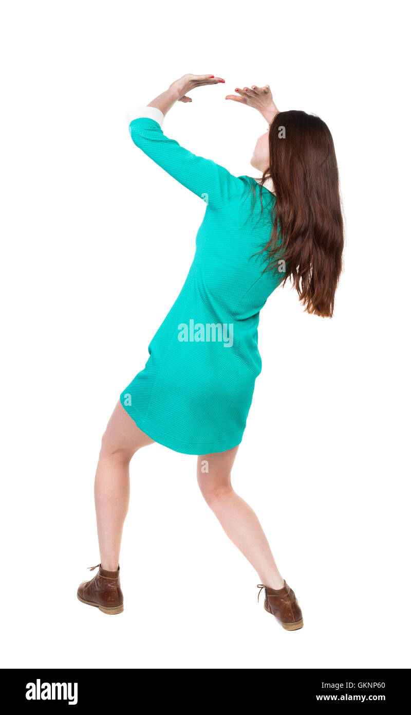 back view woman in a dress protects hands from what is falling f Stock ...
