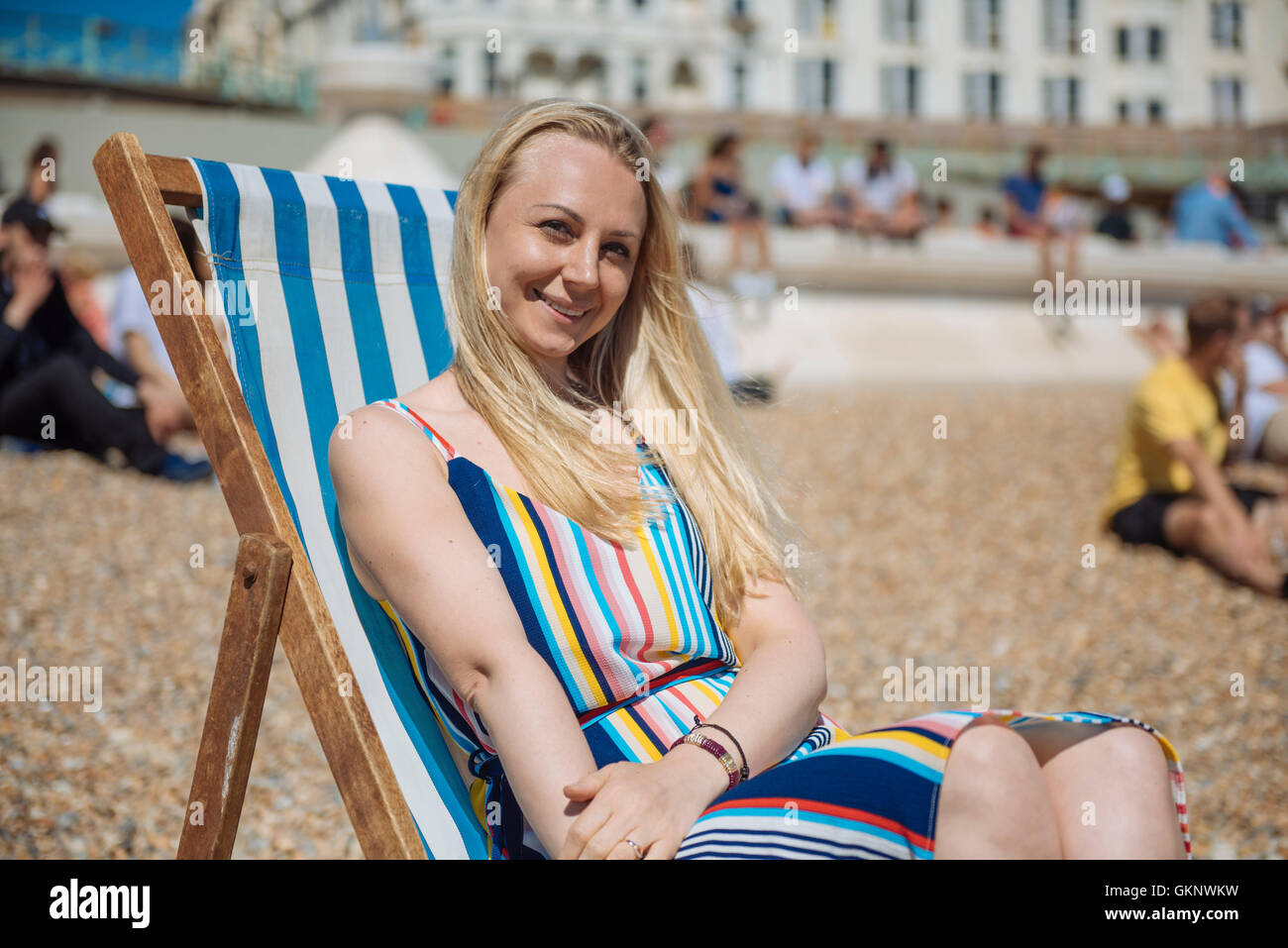 Woman sitting in beach chair hi-res stock photography and images - Alamy
