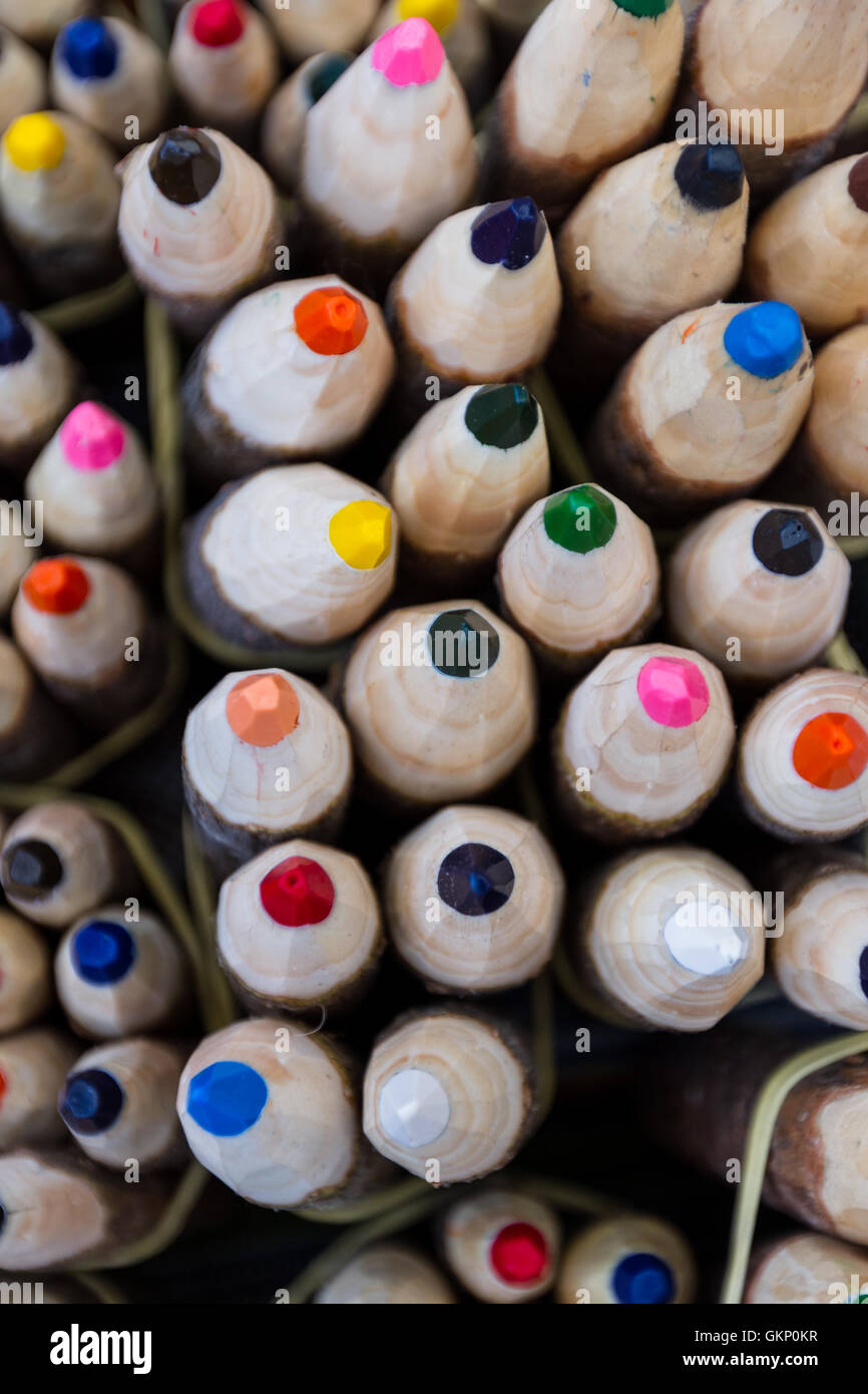 close up of a bunch of oversized crayons wrapped with a rubber band ...