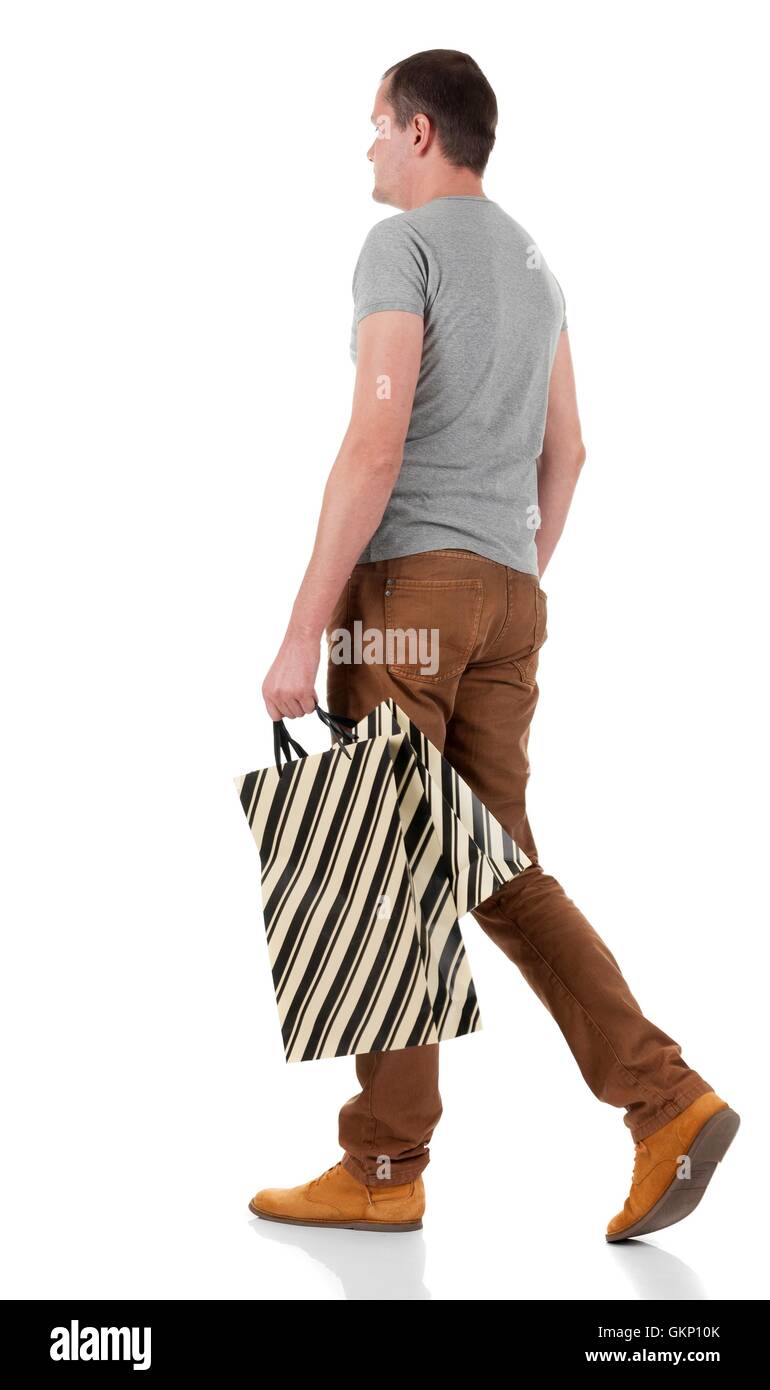 Back view of going handsome man with shopping bags Stock Photo - Alamy