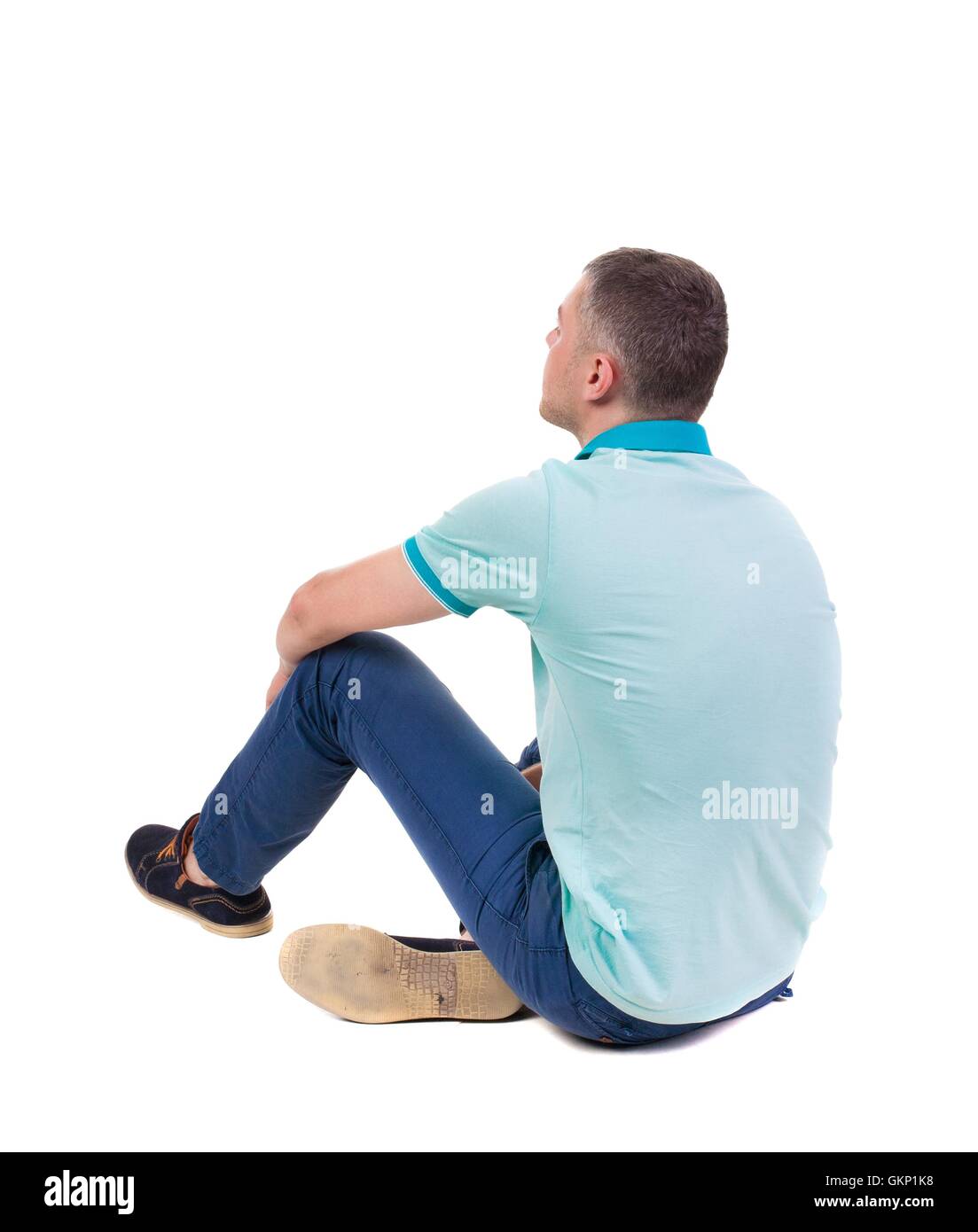 Back view of seated handsome man in polo looking up Stock Photo - Alamy
