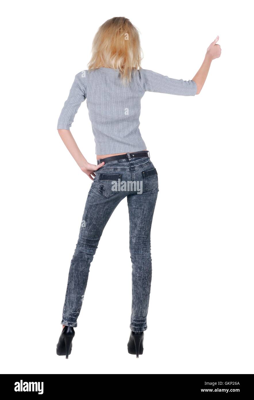 Beautiful young woman looking at wall Stock Photo - Alamy