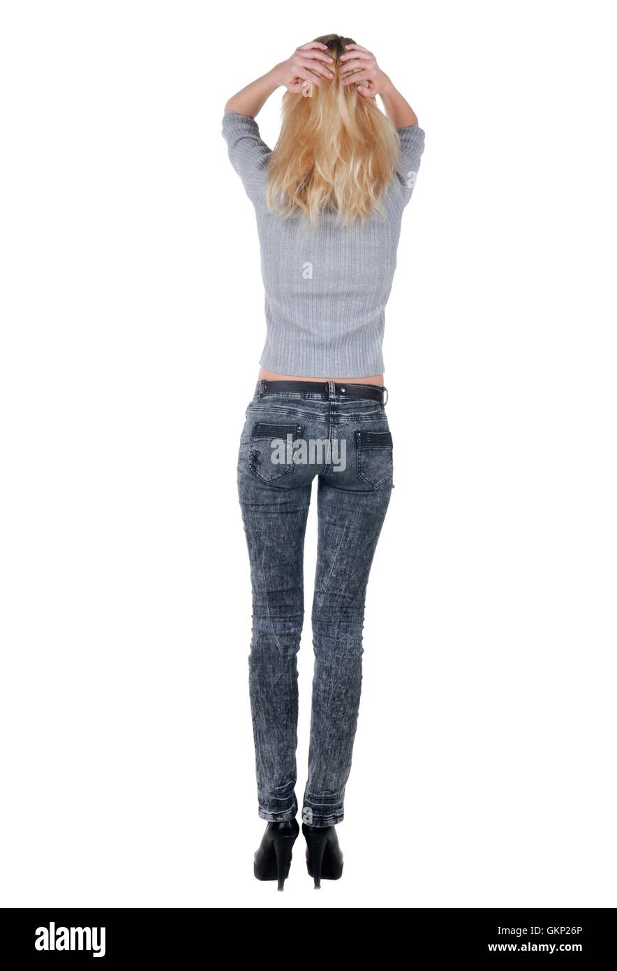 Beautiful young woman looking at wall Stock Photo - Alamy