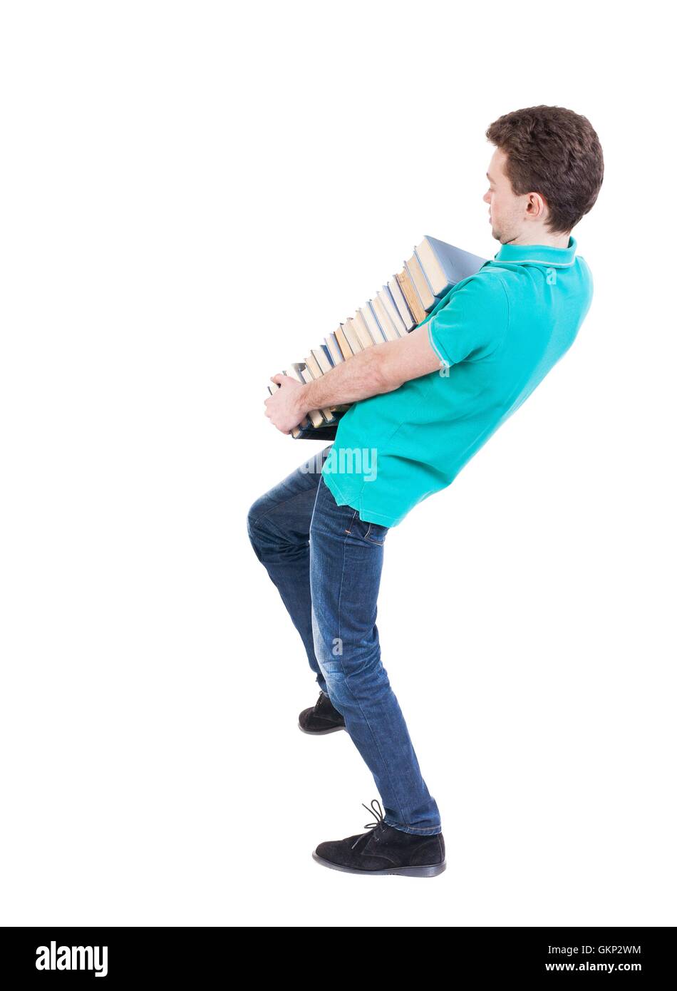 Back view of going handsome man carries a stack of books Stock Photo ...