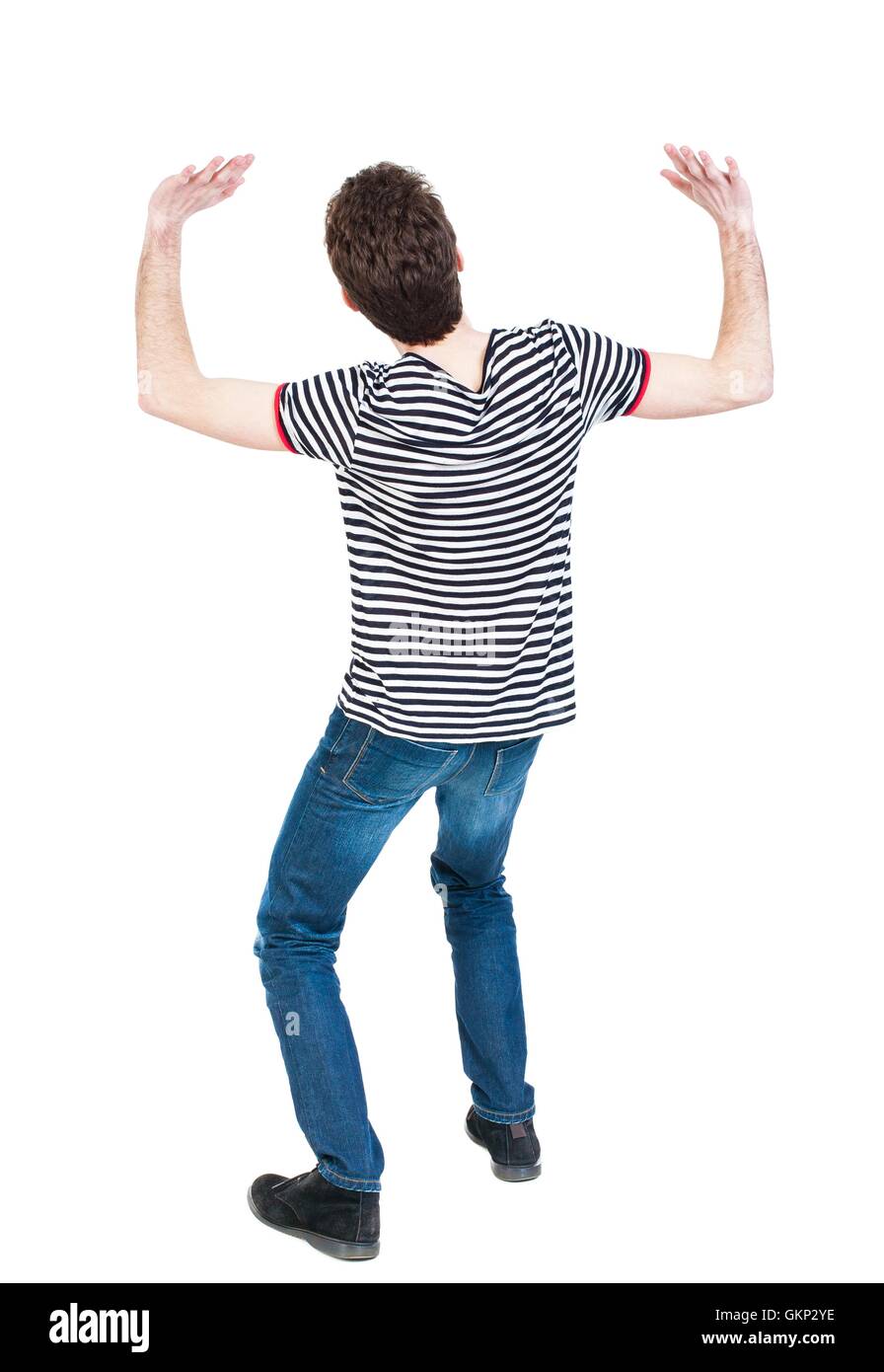 back view. man protects hands from what is falling from above Stock ...