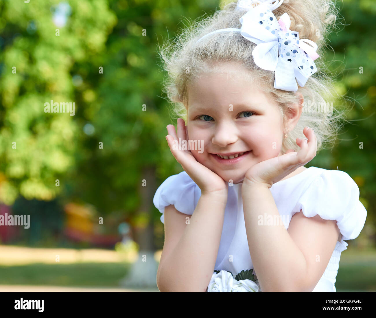 child girl portrait touch face closeup, posing in white gown, happy ...