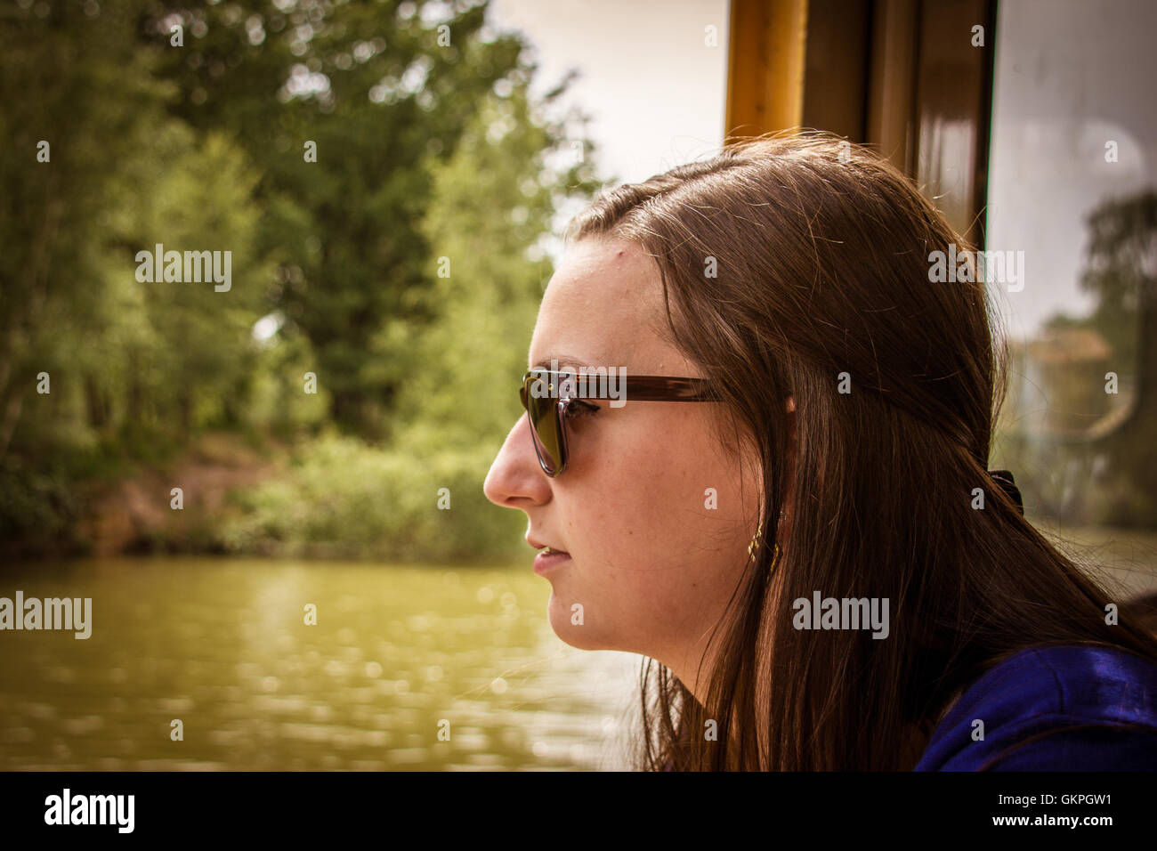 Young beautiful woman looking through window with sunglasses Stock ...