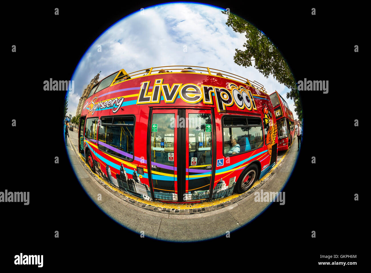 Sight seeing open top bus at the city centre decorated with images of ...