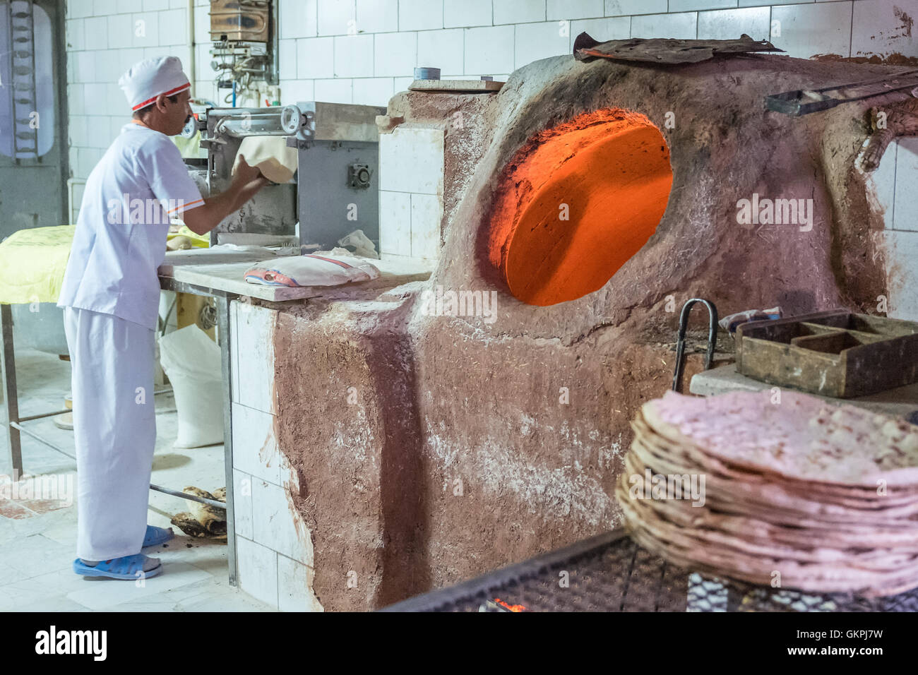 Iranian baker baking beautiful Persian Taftoon Bread using Tandoor Oven ...