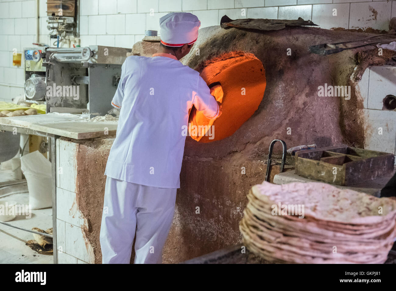 Persian baker baking beautiful Persian Taftoon Bread using tandoor oven ...