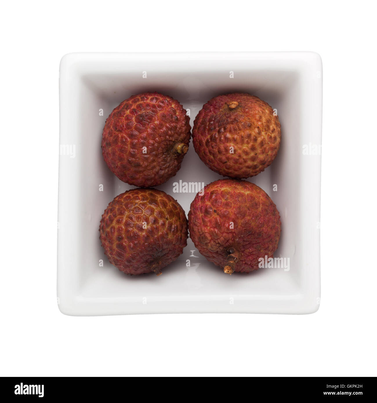 Four lychees in a square bowl isolated on white background Stock Photo ...