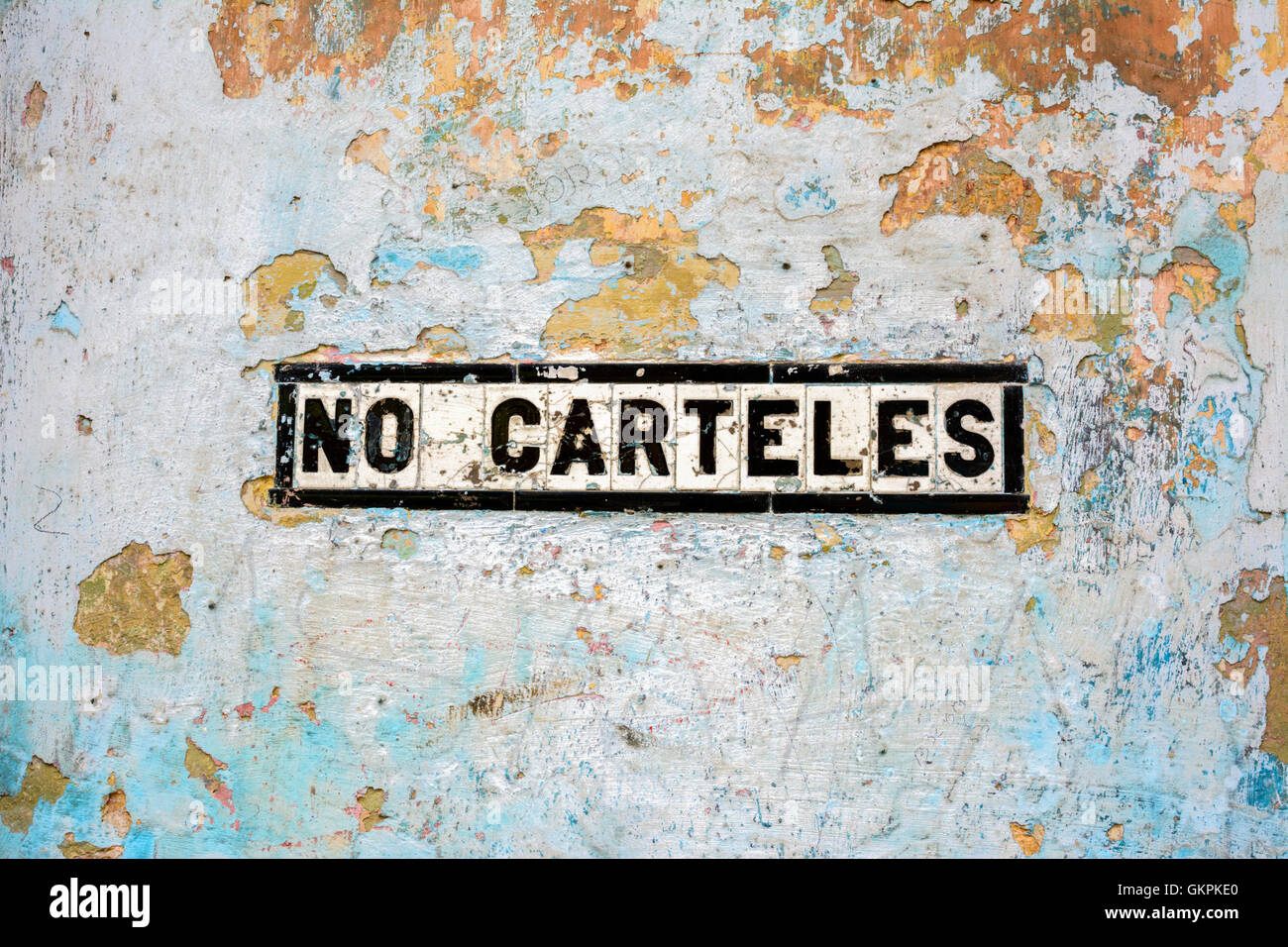 Street sign saying "no posters" in Havana on a weathered paint peeling ...