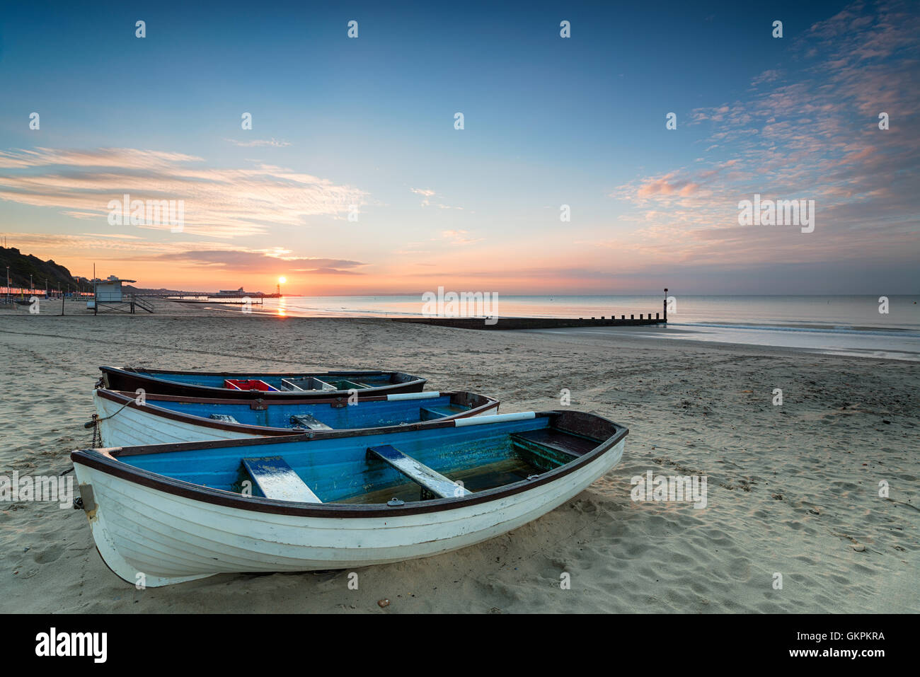 Beautiful sunrise over boats on the beach at Durley Chine in ...