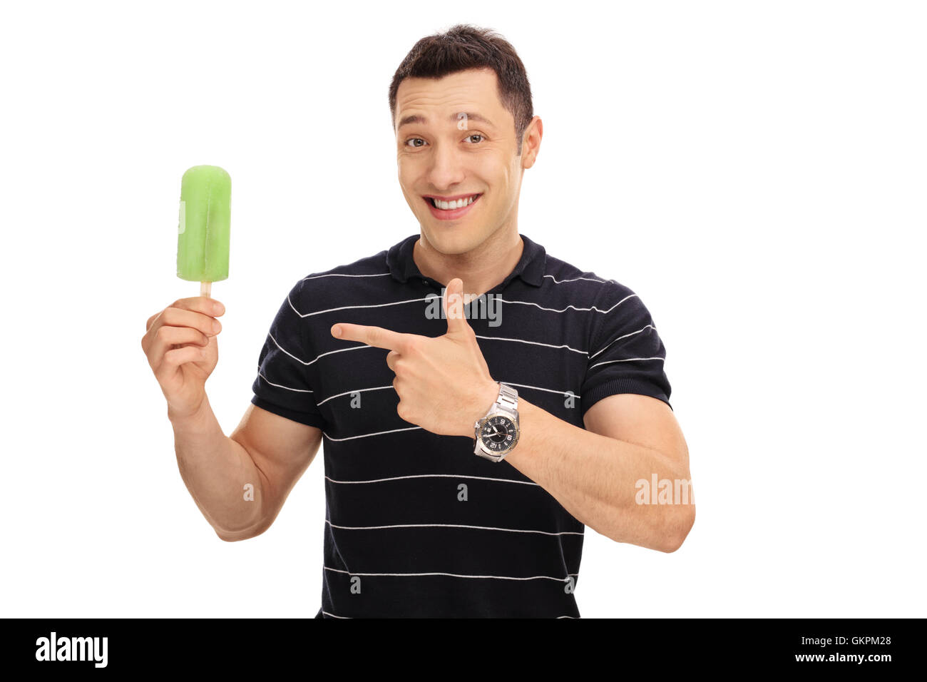 Smiling guy holding an ice cream and pointing at it isolated on white ...