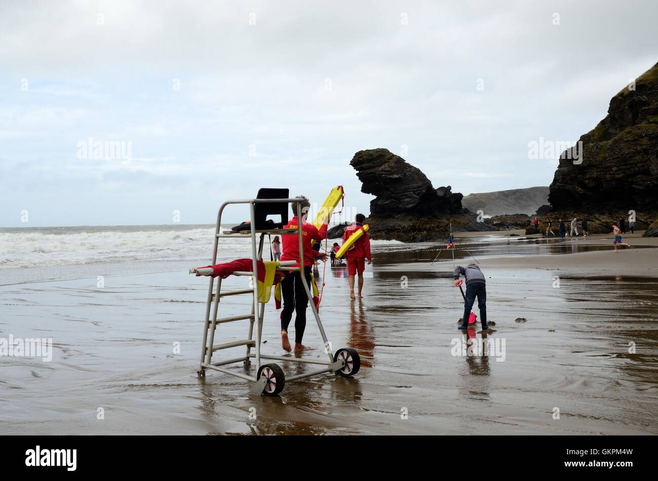 RNLI Lifeguards watching patrolling a beach on a stormy day Llangrannog ...