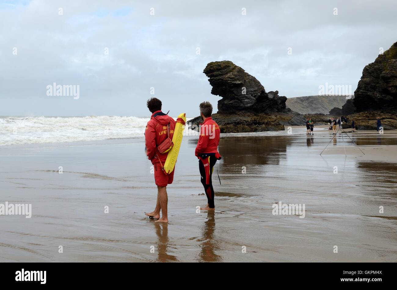 RNLI Lifeguards watching patrolling a beach on a stormy day Llangrannog ...