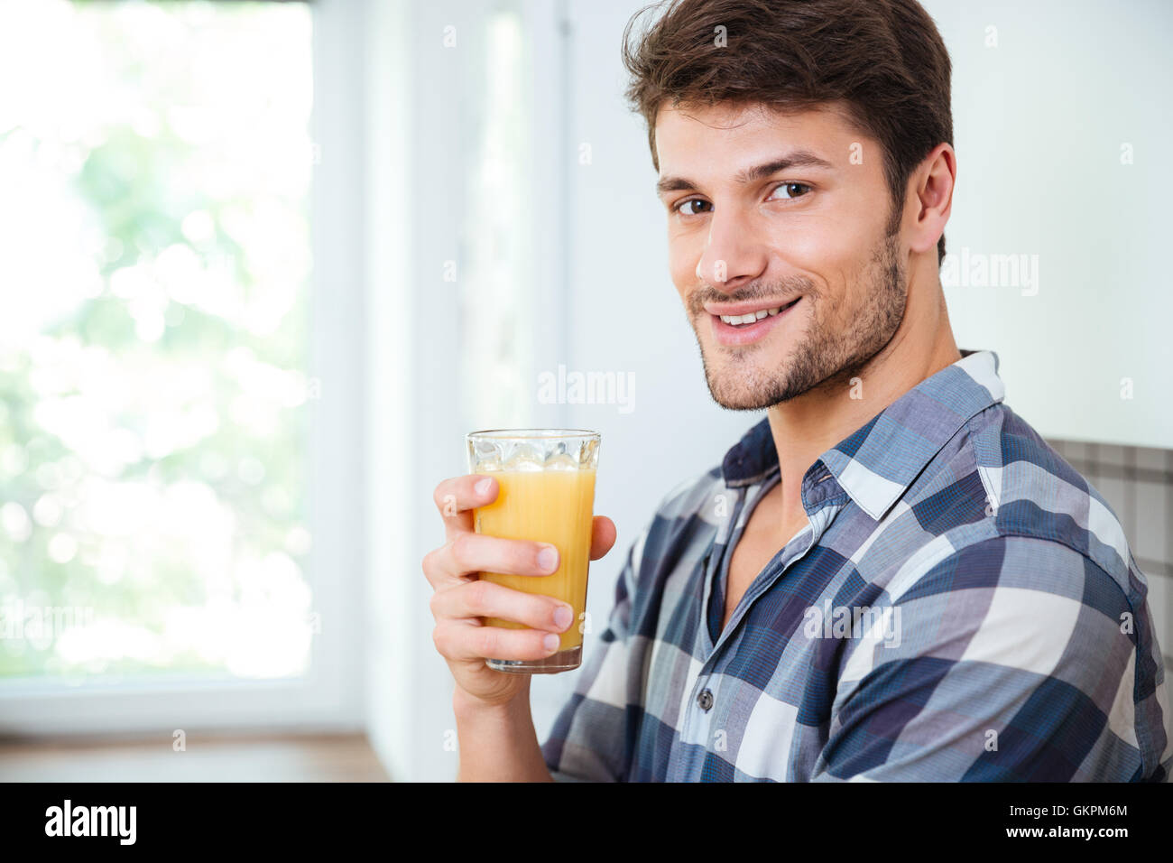 Attractive guy drinking juice smiling hi-res stock photography and ...