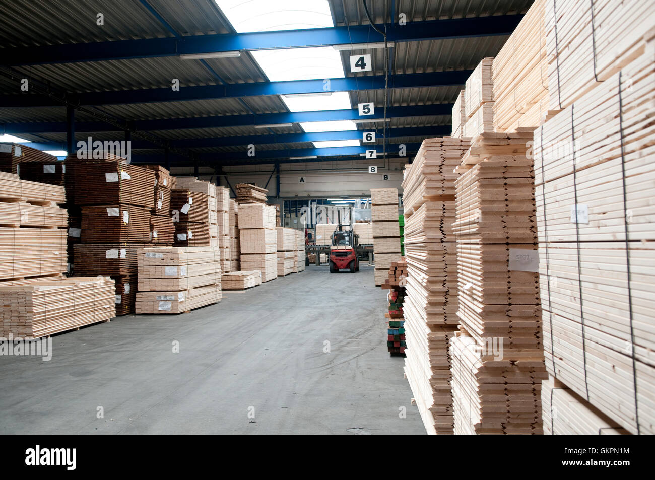 Construction timber piled up in a wharehouse Stock Photo - Alamy