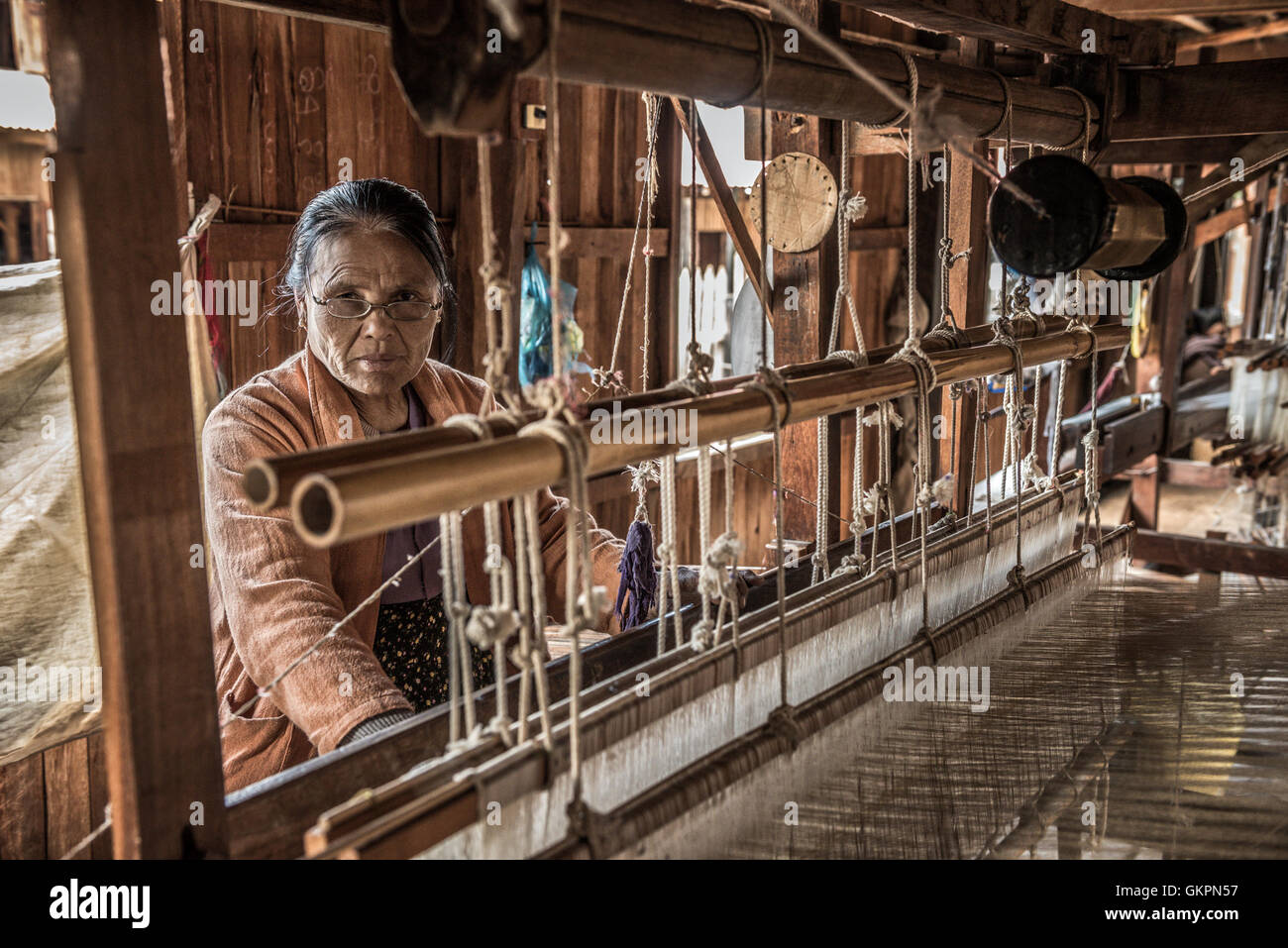 Woman worker weaves fabric in a weaving factory on Inle Lake Stock ...