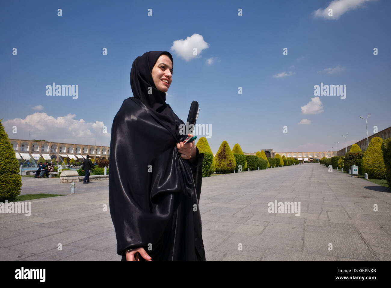 Iranian tour guide wearing a black chador in Naqsh-e Jahan Square in ... Iranian tour guide wearing a black chador in Naqsh-e Jahan Square in ...