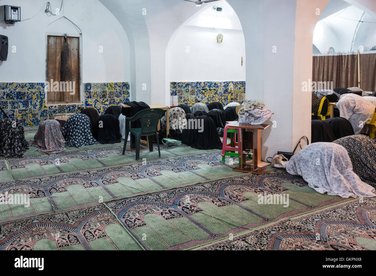 Women in chadors pray facing Mecca in the Shah Mosque in Isfahan, Iran ...