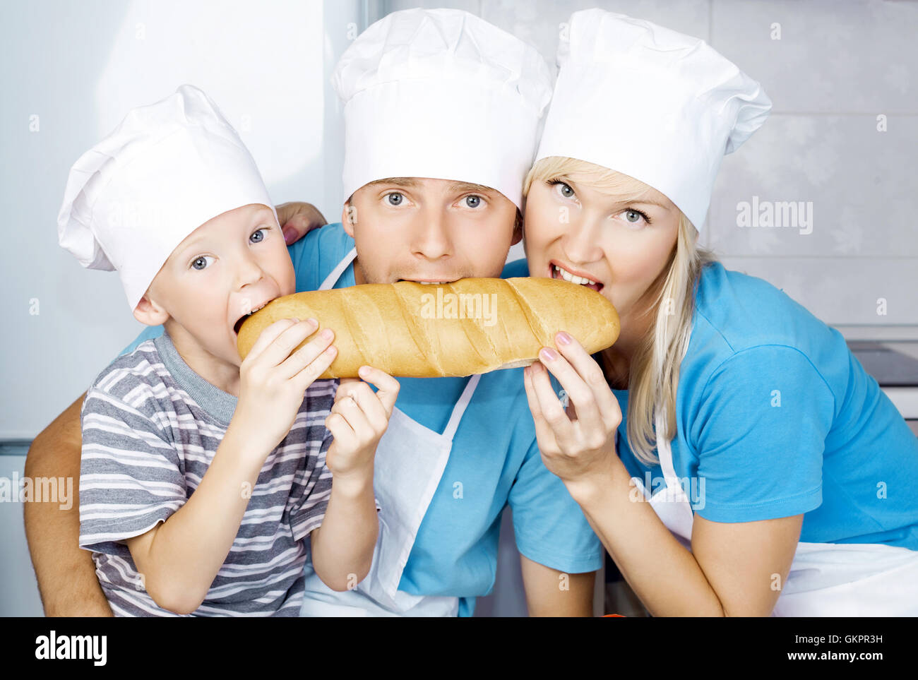 mother, father and son in the kitchen with bread Stock Photo - Alamy